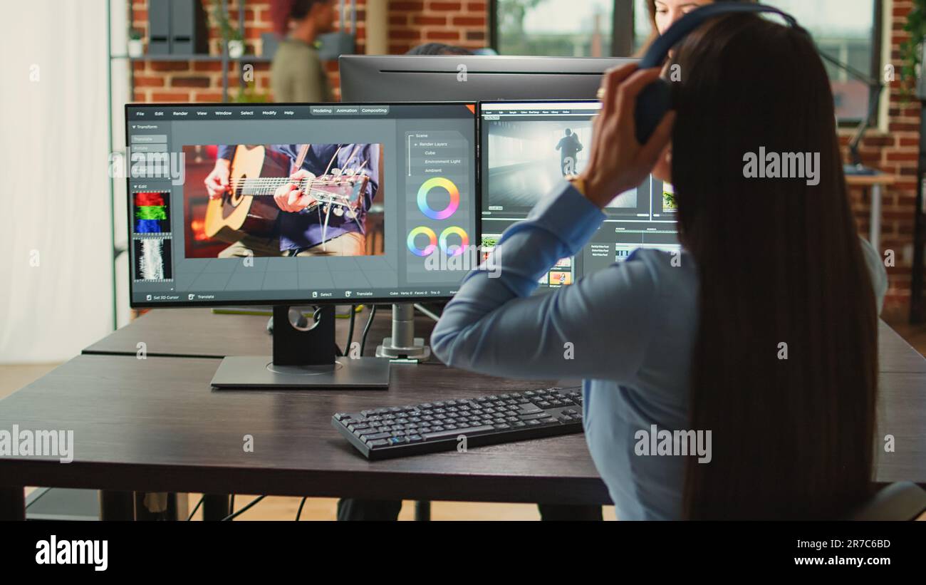 Female cinematographer editing video montage in post production studio ...