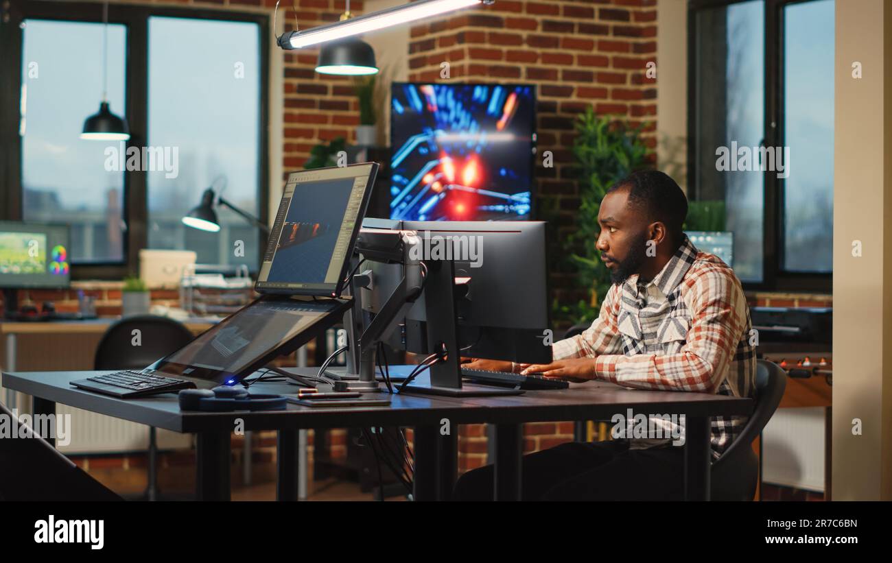 African american web developer working in artistic office to create CGI ...