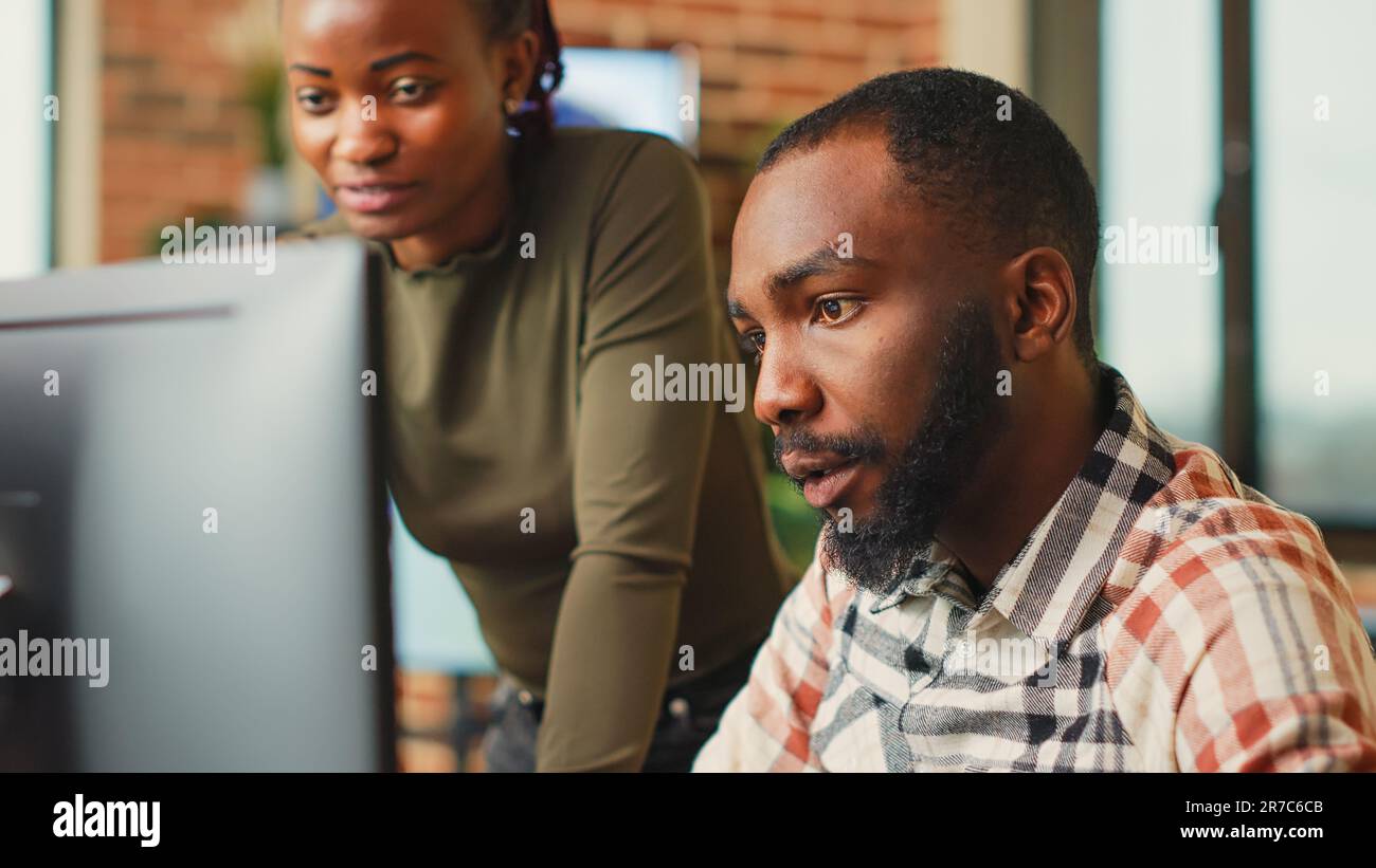 African american team of engineers working with 3d modelling software, brainstorming new ideas ...