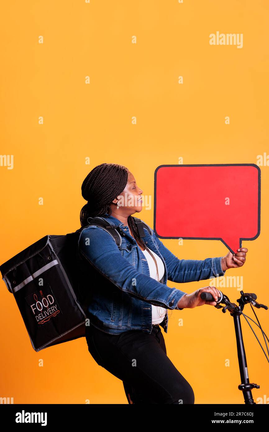 Pizzeria employee carrying takeaway thermal backpack while riding ...