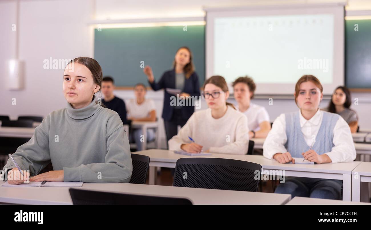 Teenage students at desks writing hi-res stock photography and images ...