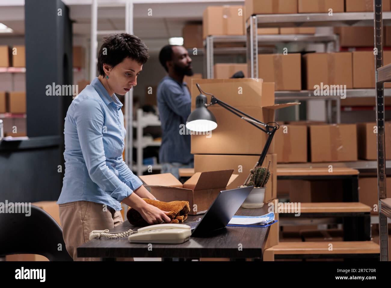 Employee analyzing at cargo stock on laptop computer before start ...