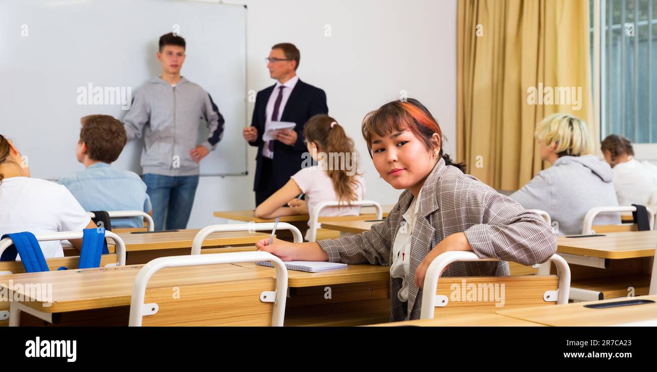 Asian teenage schoolgirl sitting on lesson in classroom Stock Photo - Alamy