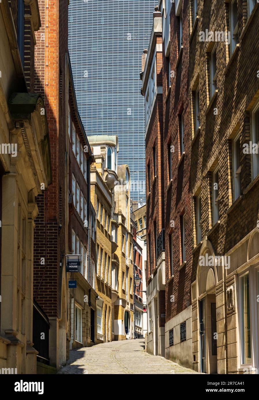 Narrow street of Lovat Lane in City of London with skyline dominated by ...