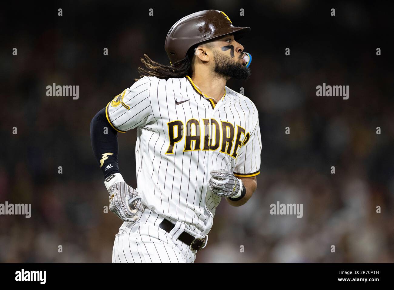 San Diego Padres' Fernando Tatis Jr. blows a bubble while running the ...