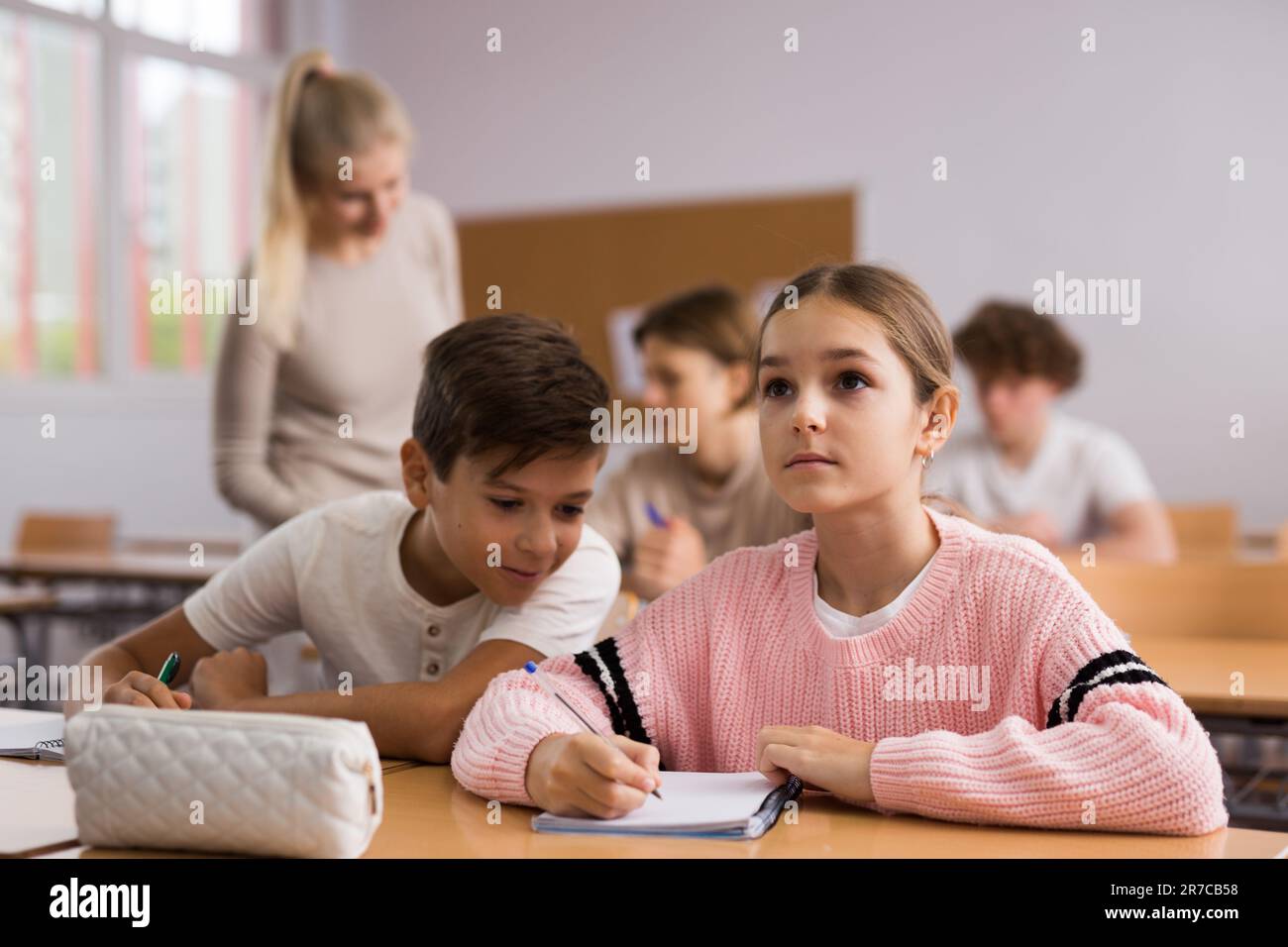 Boy and girl studying in classroom Stock Photo - Alamy