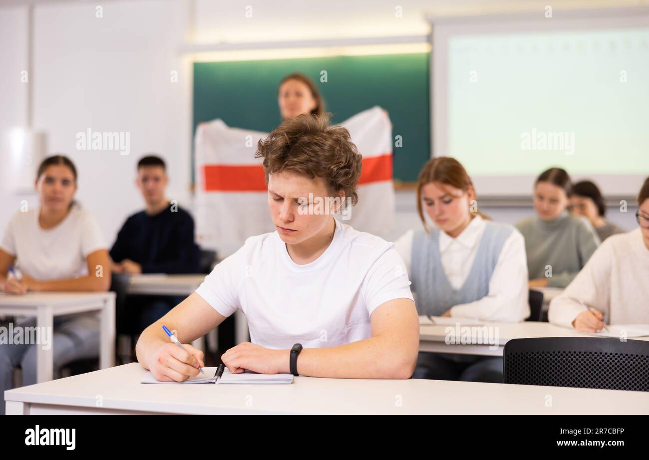 Young boy student studying diligently at school Stock Photo - Alamy