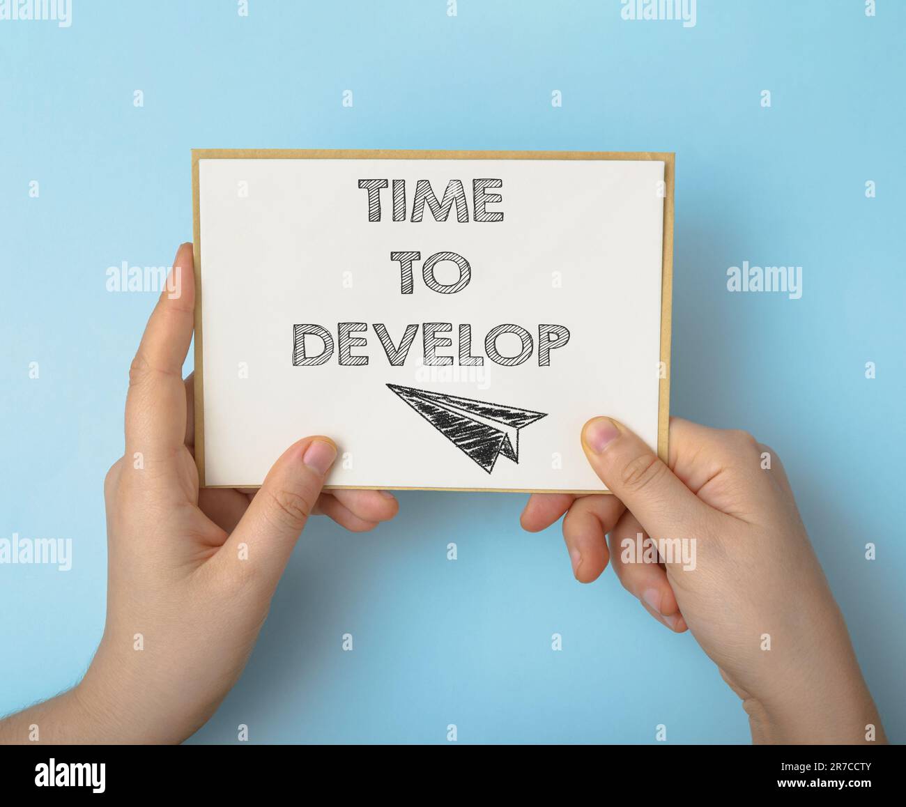 Text on a white sheet Time to develop Stock Photo - Alamy