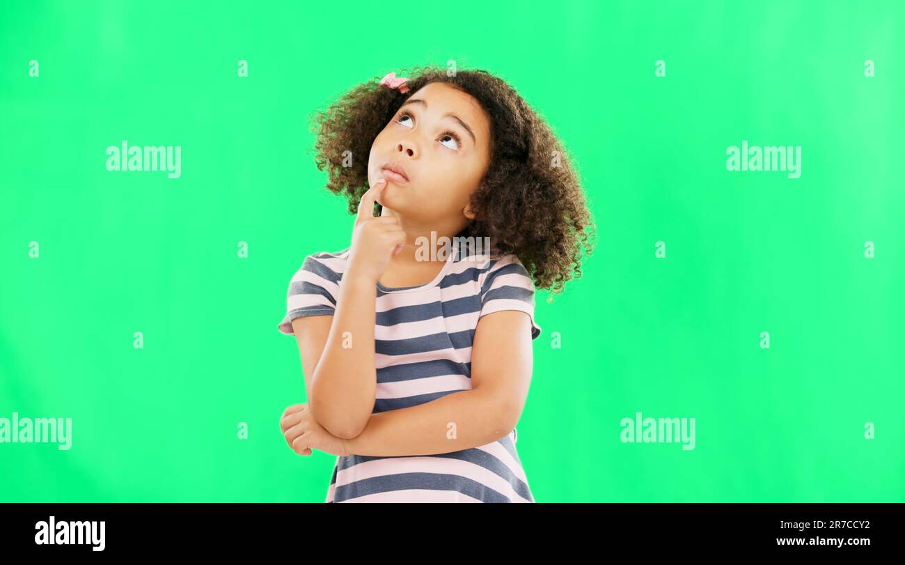 Thinking, idea and green screen with young girl in a studio ...