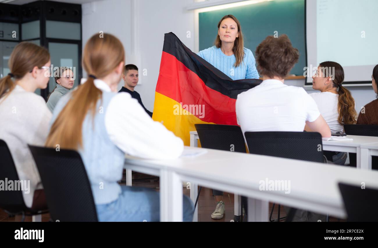 Female professor shows students flag of Germany Stock Photo - Alamy