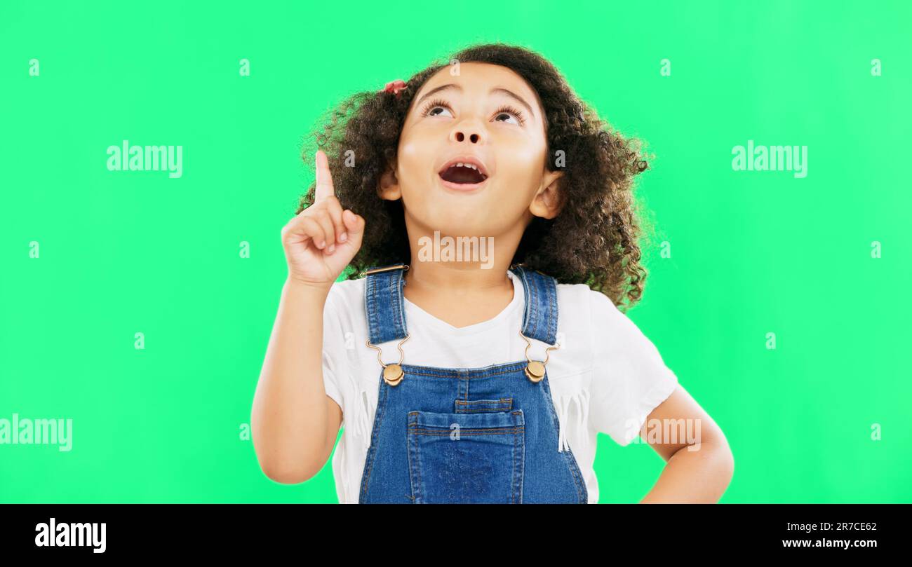 Idea, thinking and child pointing up at mockup space or green screen ...