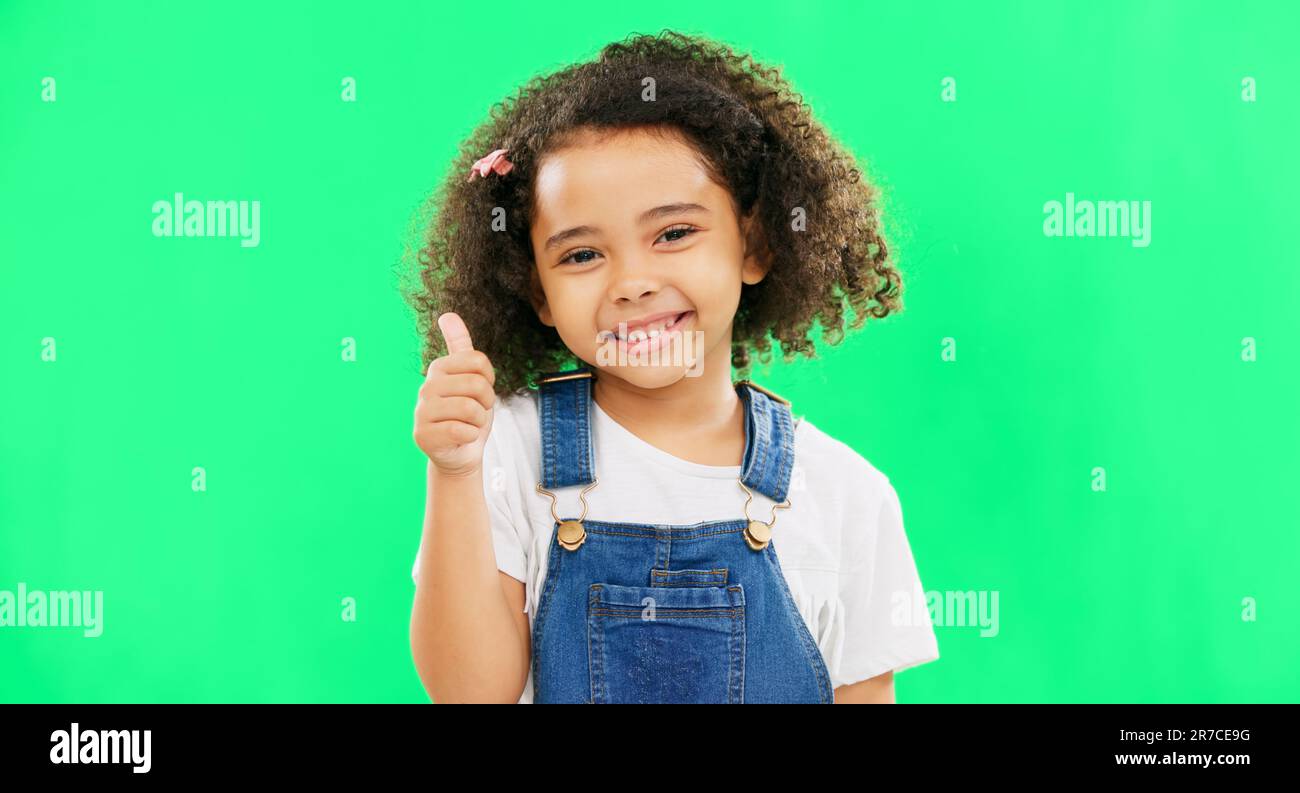 Happy, green screen and face of a child with a thumbs up isolated on a ...