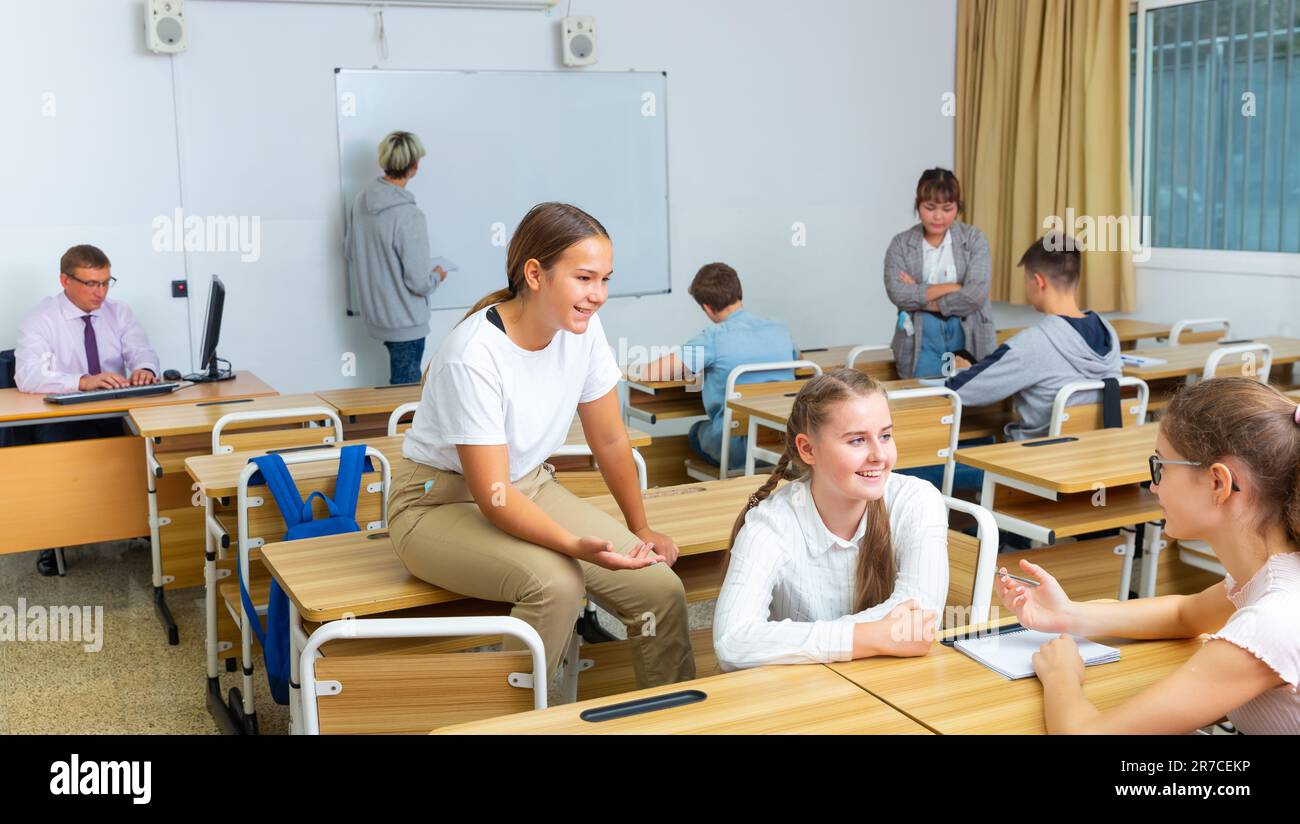 Teenage students talking during recess between lessons Stock Photo - Alamy