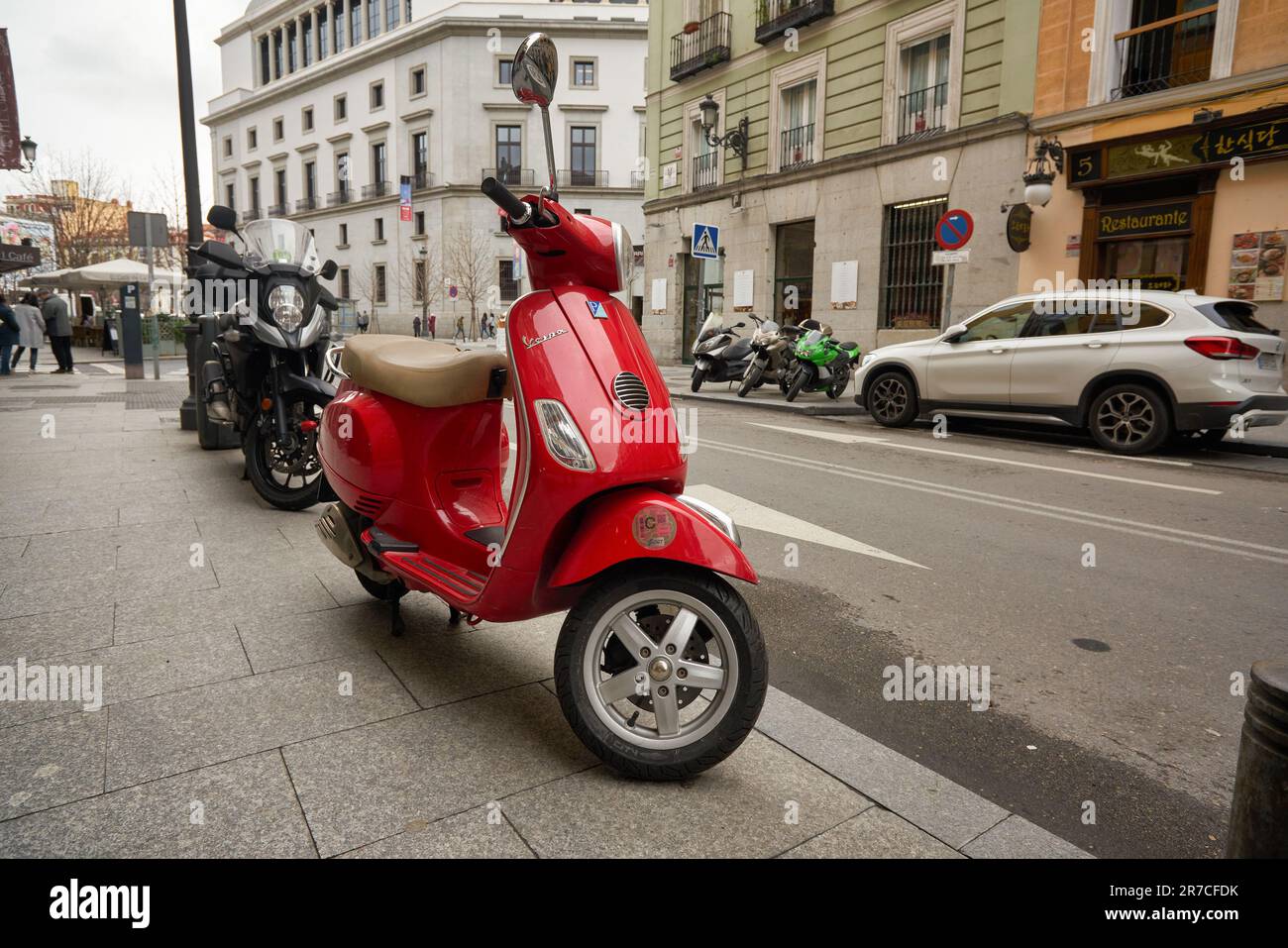 MADRID, SPAIN - CIRCA JANUARY, 2020: red Vespa scooter parked on street ...