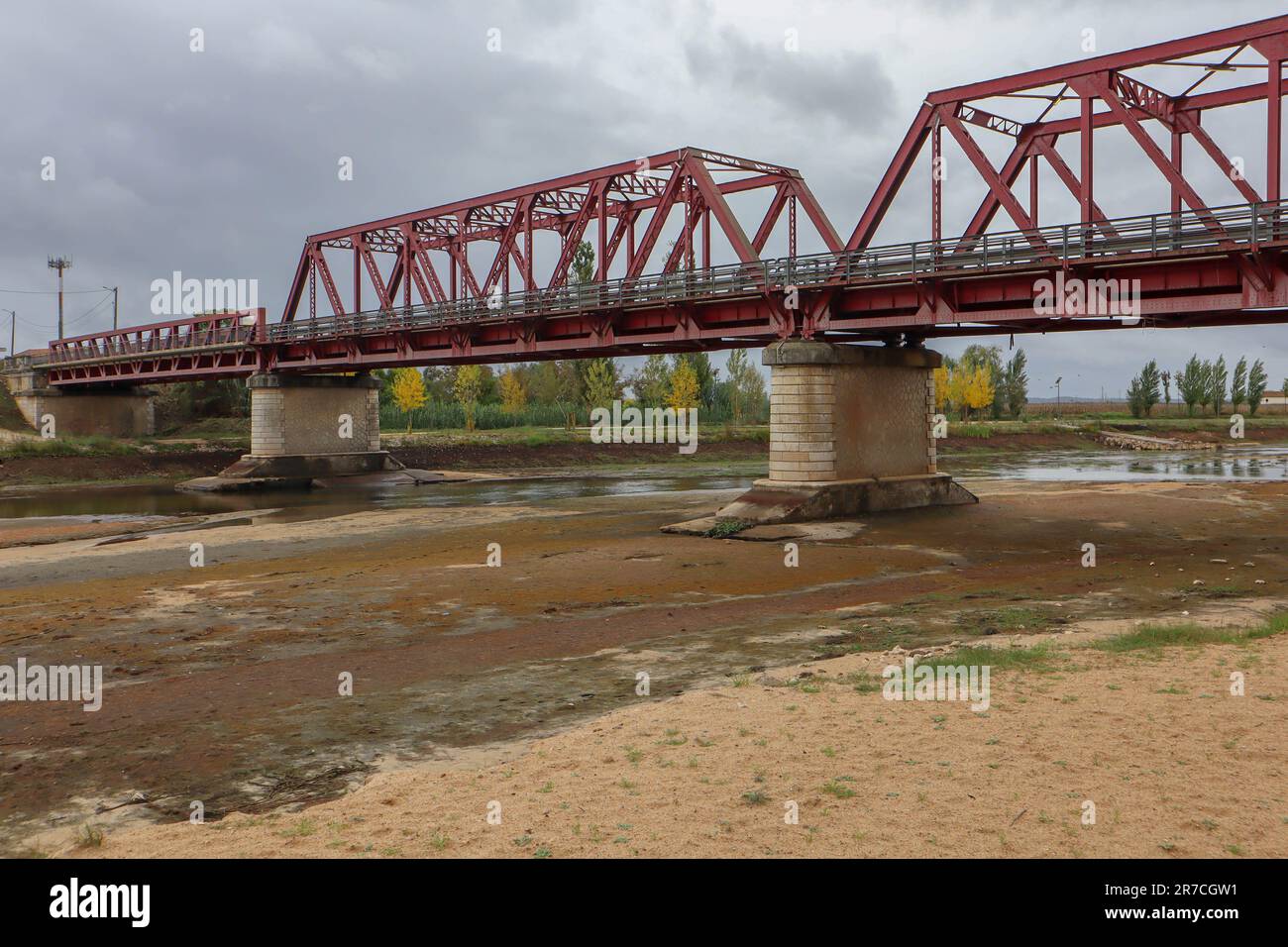 Drought in Sorraia river with Red Iron Bridge in background at Coruche ...