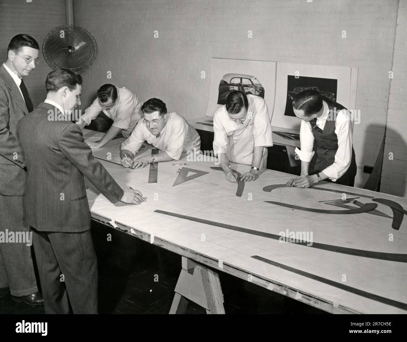 United States: c. 1940 A design team working on an automobile layout ...