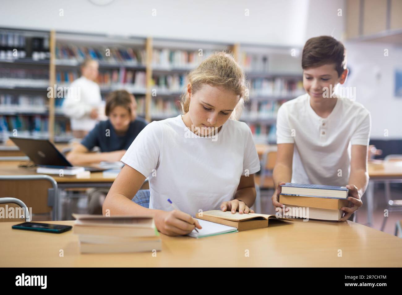 Fifteen-year-old girl writes out a synopsis Stock Photo - Alamy