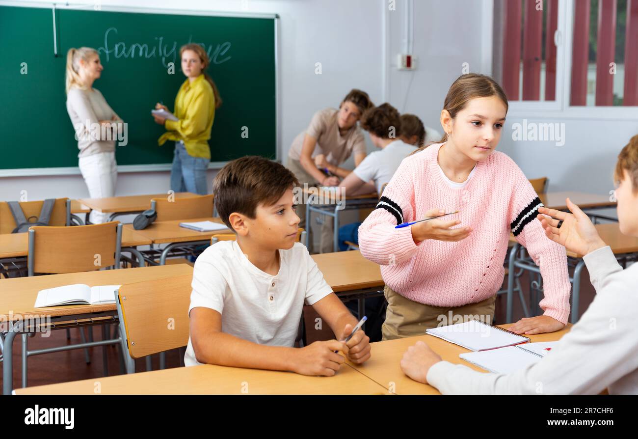 Pupils performing group tasks in classroom Stock Photo - Alamy