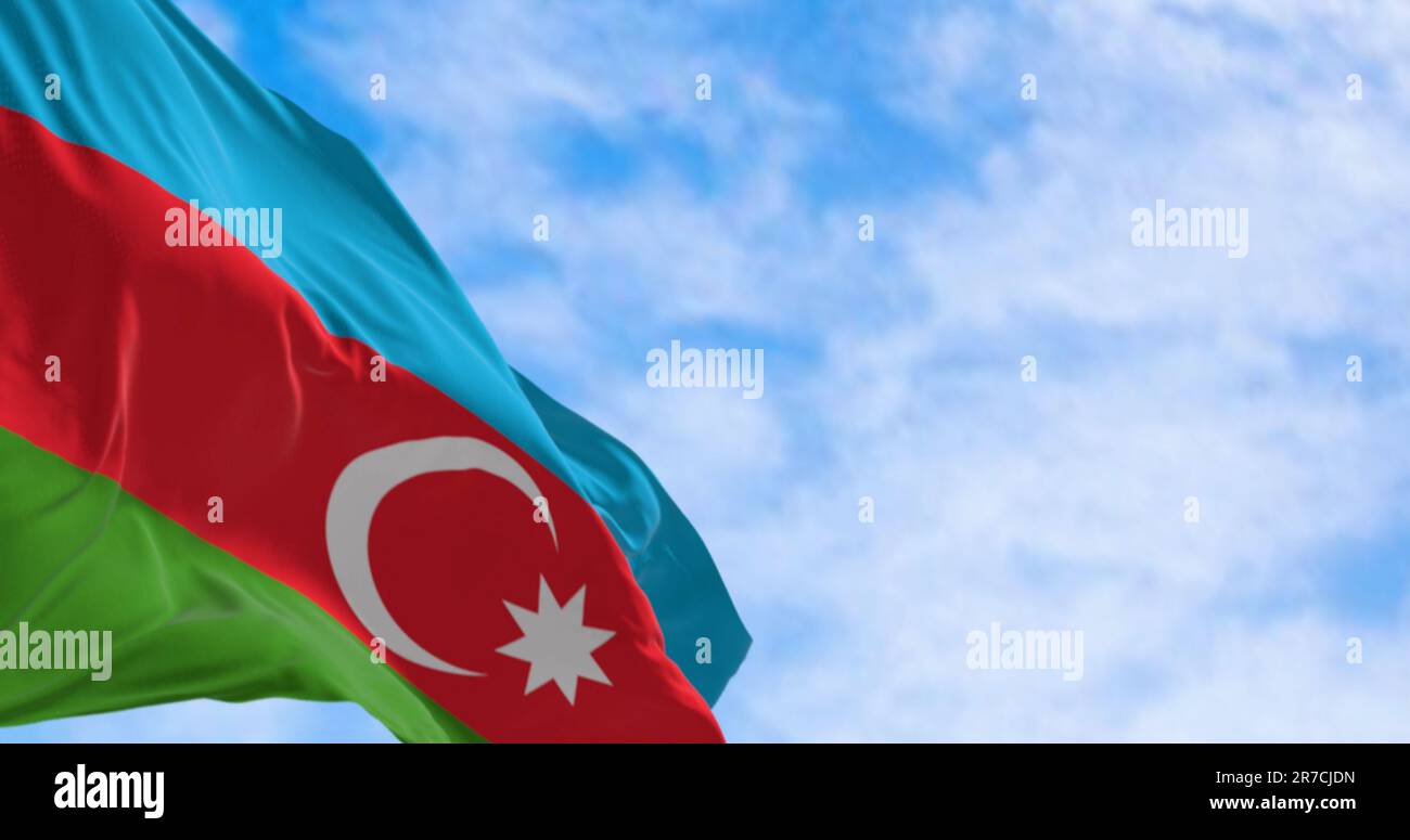 The national flag of Azerbaijan waving in the wind on a clear day ...