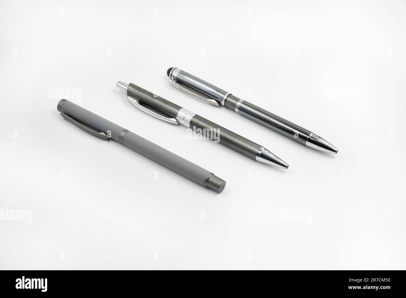 A top view of three different types of pens on a white background Stock ...