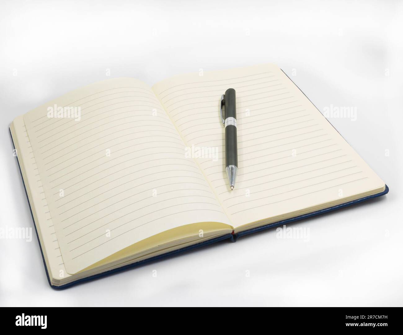 An open hardcover notebook with a pen on it, with copy space Stock ...