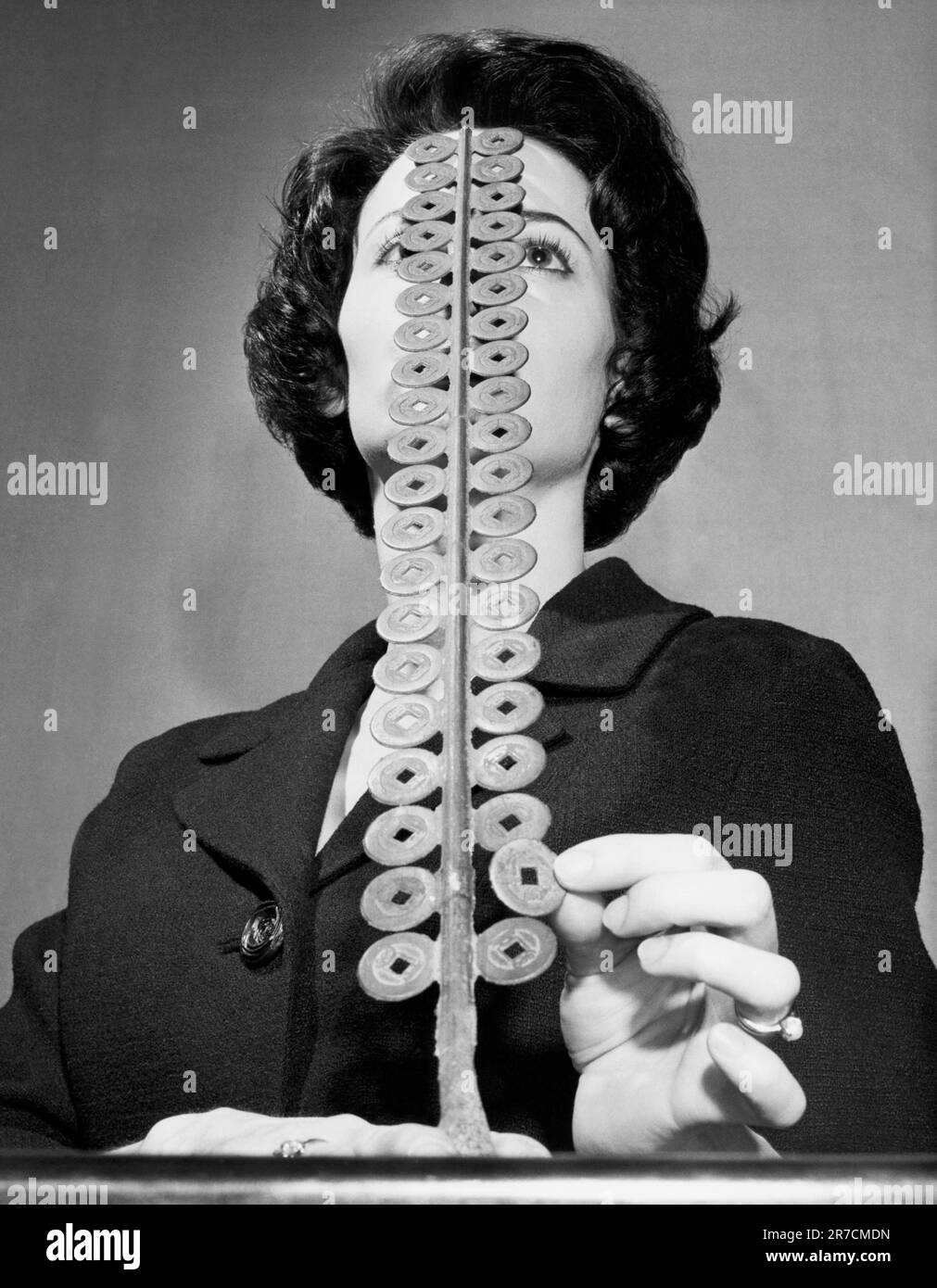 United States: c. 1960 A woman takes a look at a Chinese "Tree of Cash ...