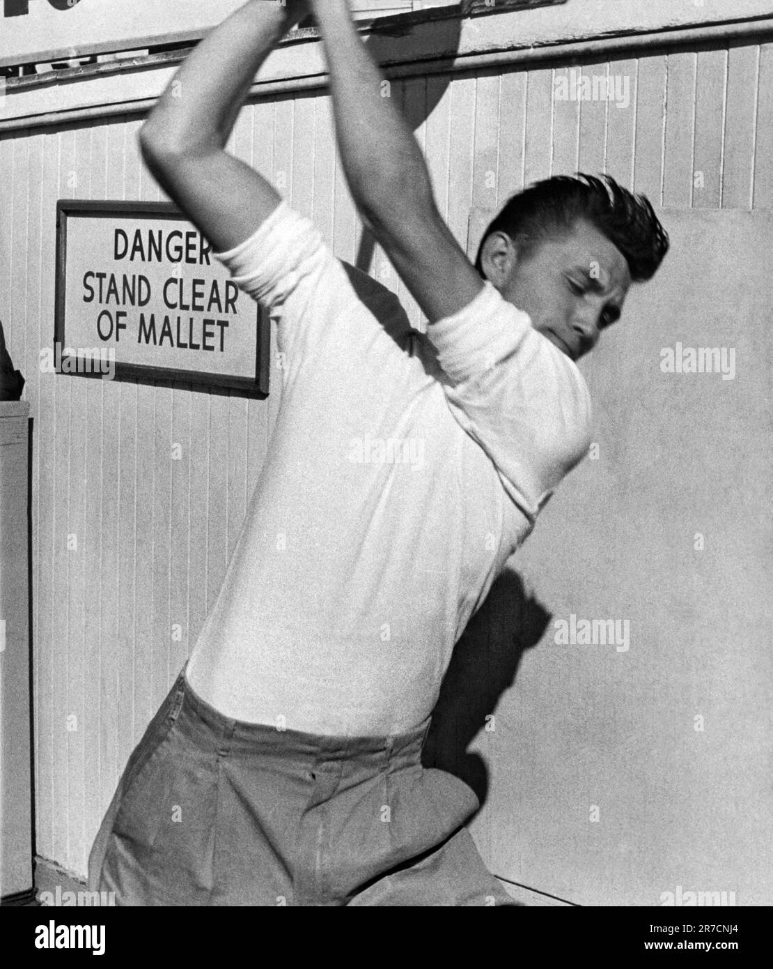 San Francisco, California: c. 1951. A man tests his strength by trying ...