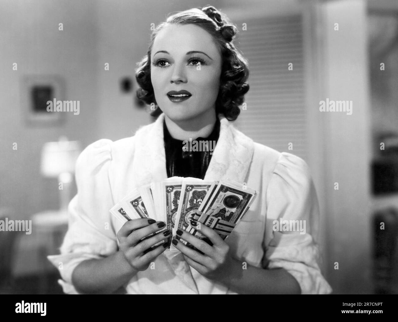 Hollywood, California: c. 1935 Actress Sally Eilers holds a handful of ...