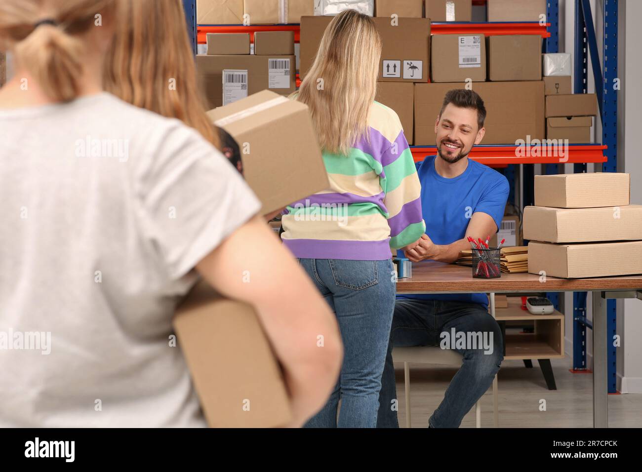 People waiting in queue at post office Stock Photo - Alamy
