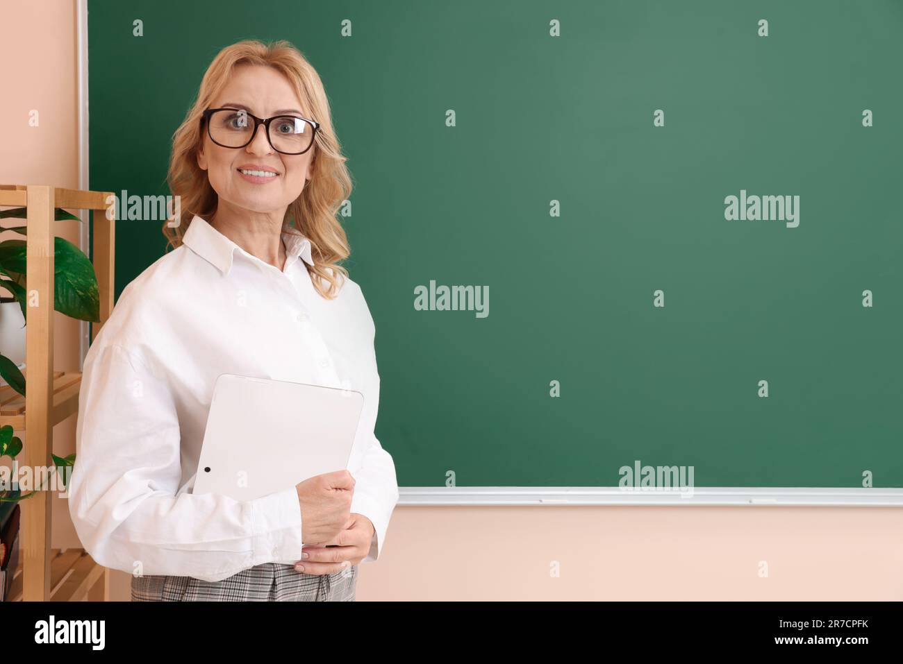 Happy professor with glasses near green board, space for text Stock ...