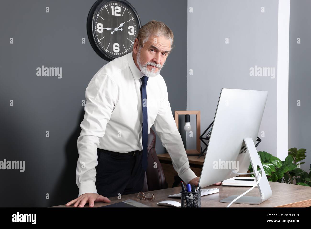 Serious senior boss near hi-res stock photography and images - Alamy