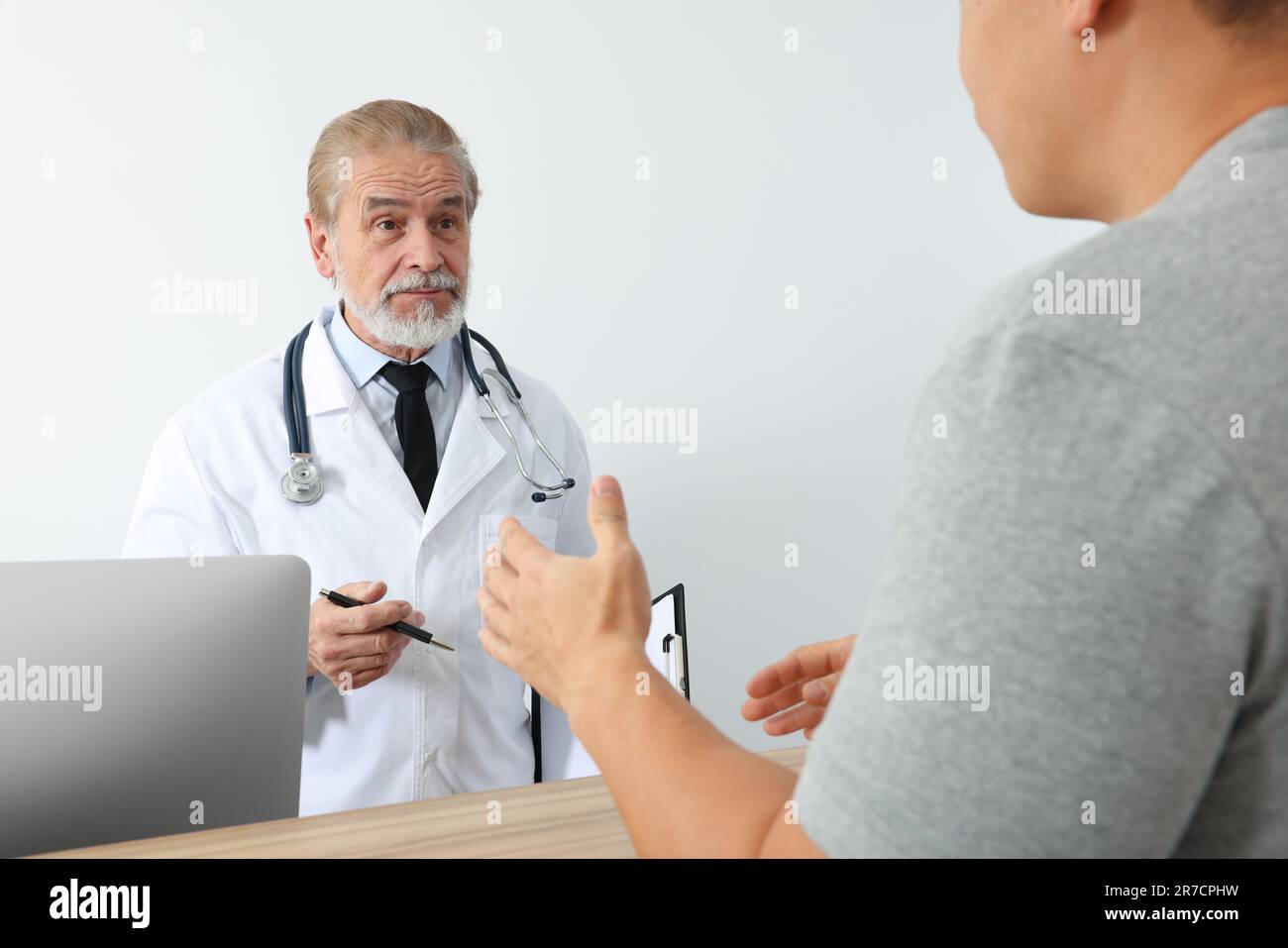Patient having appointment with doctor in clinic Stock Photo - Alamy