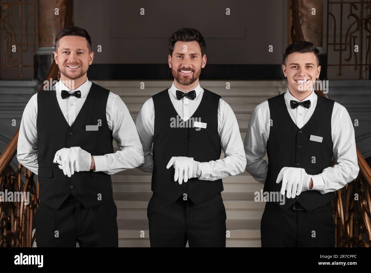 Group of trainees wearing formal clothes in hotel. Professional butler ...