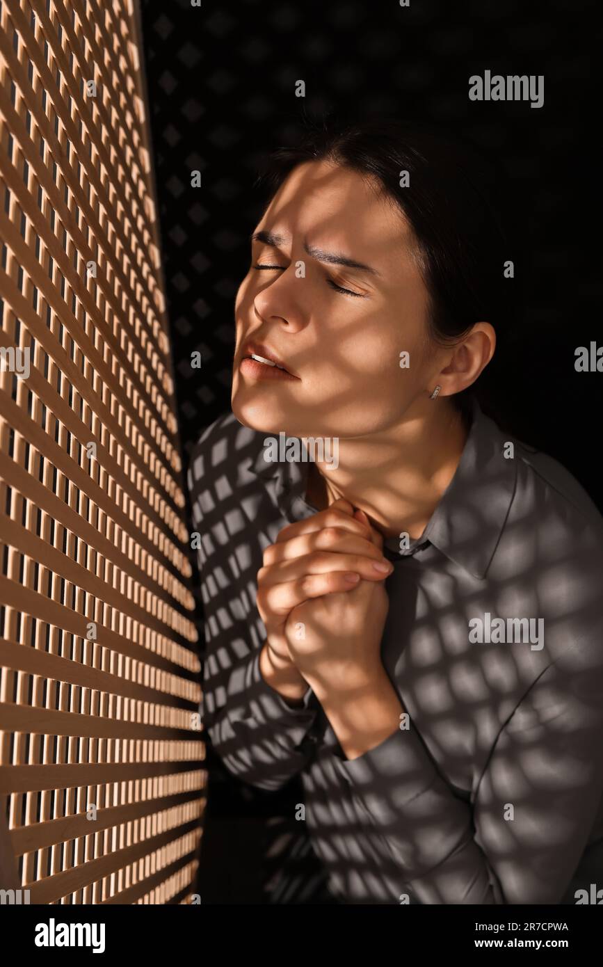 Young woman during confession in church hi-res stock photography and ...