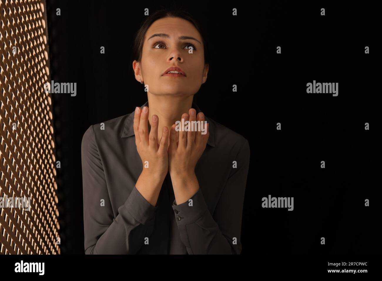 Woman praying to God during confession in booth, space for text Stock ...