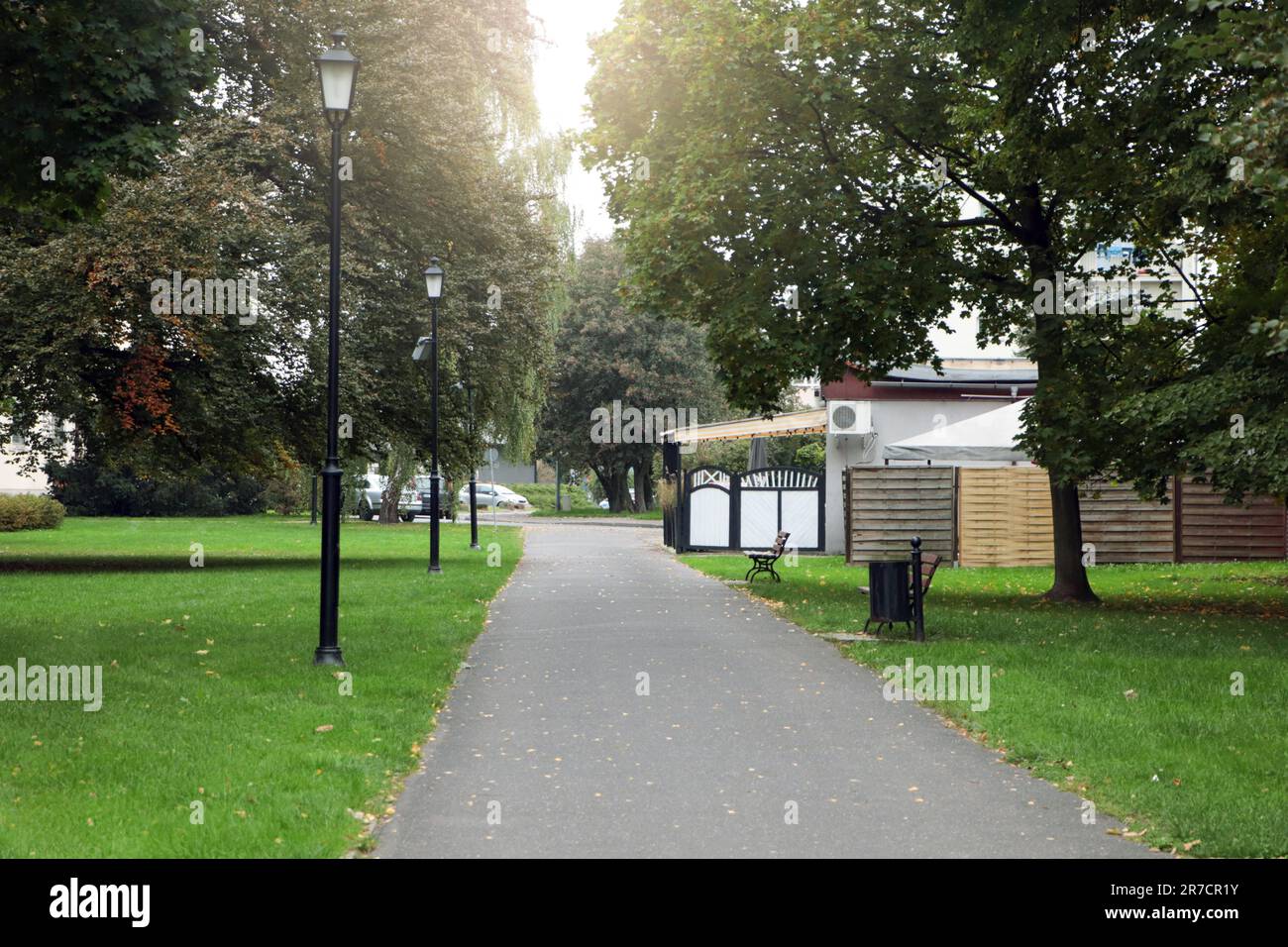 Beautiful public city park with many different plants and building ...