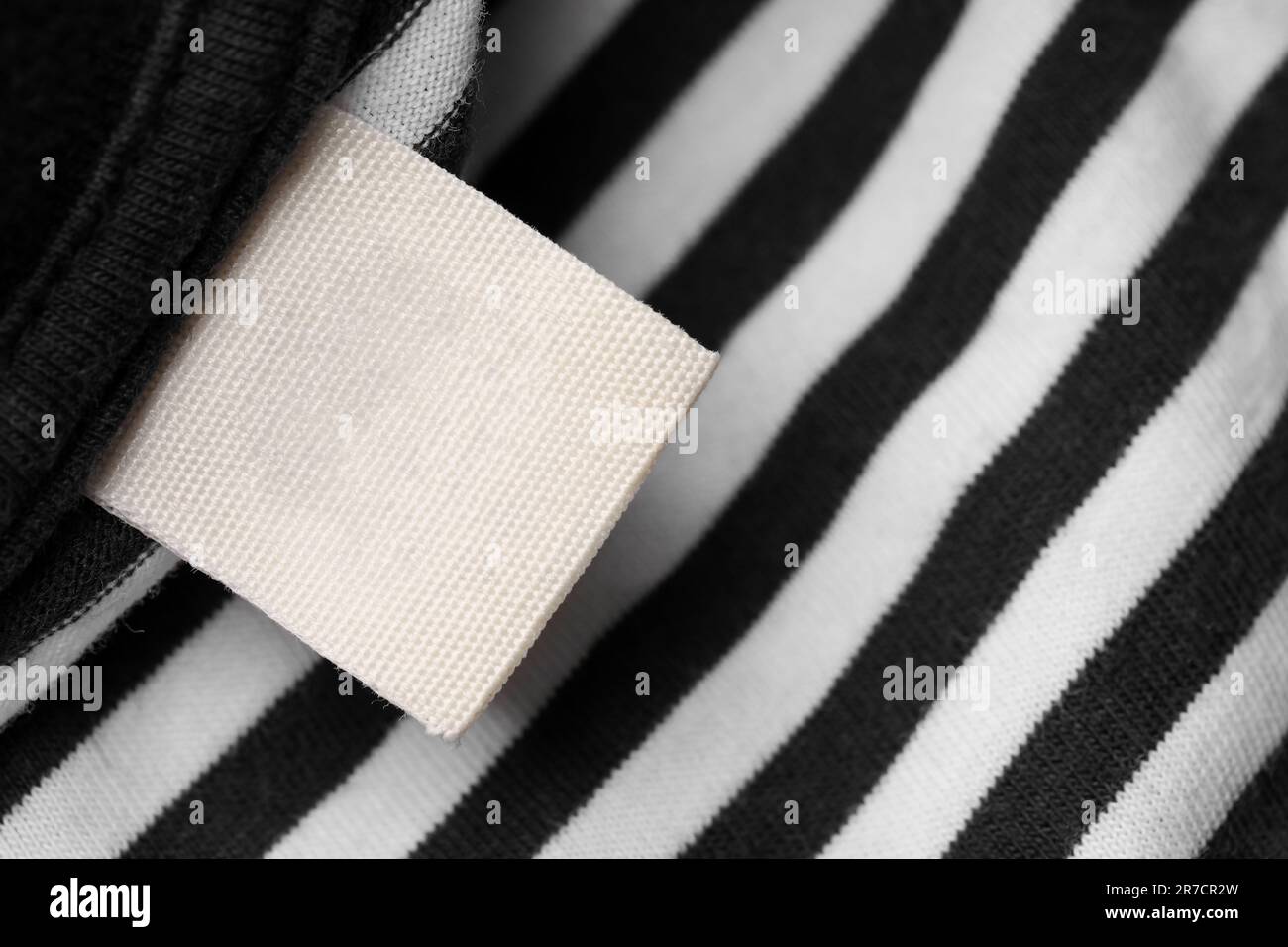 Clothing label on striped garment, top view. Space for text Stock Photo ...