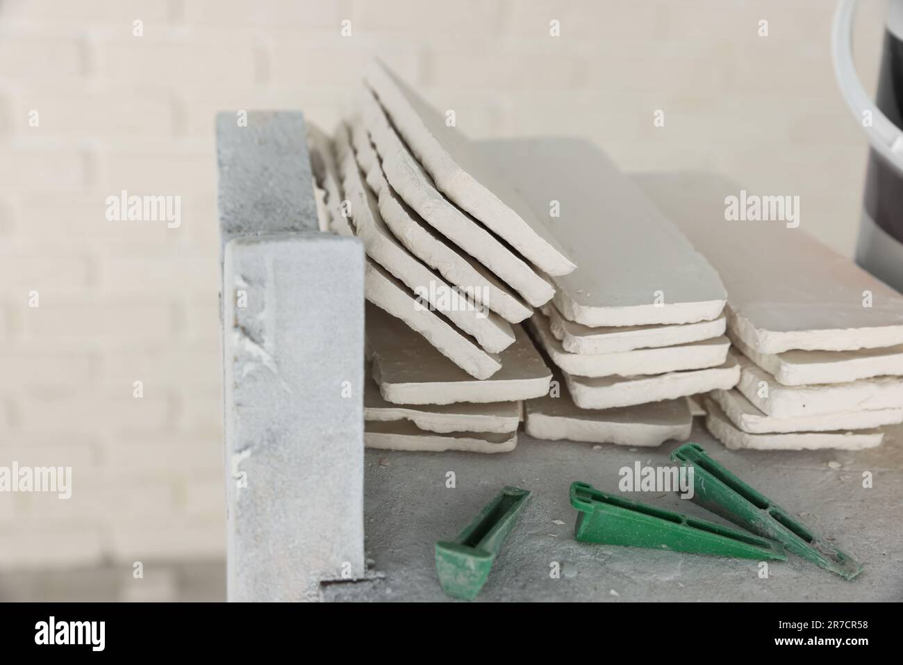 Many white decorative bricks and tile spacers in room Stock Photo - Alamy