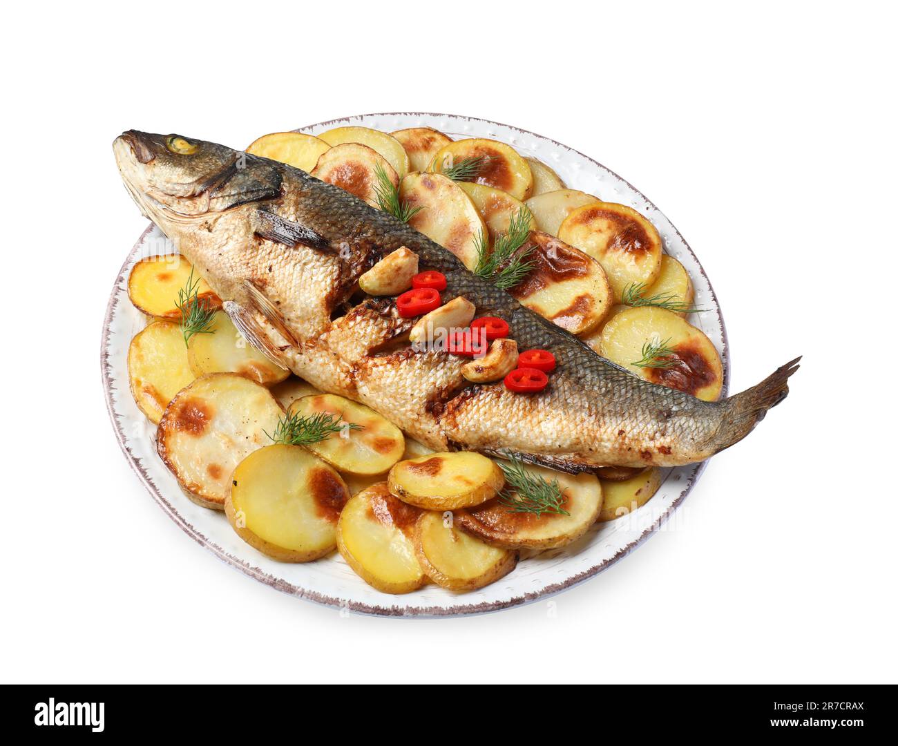 Plate with delicious baked sea bass fish and potatoes on white ...