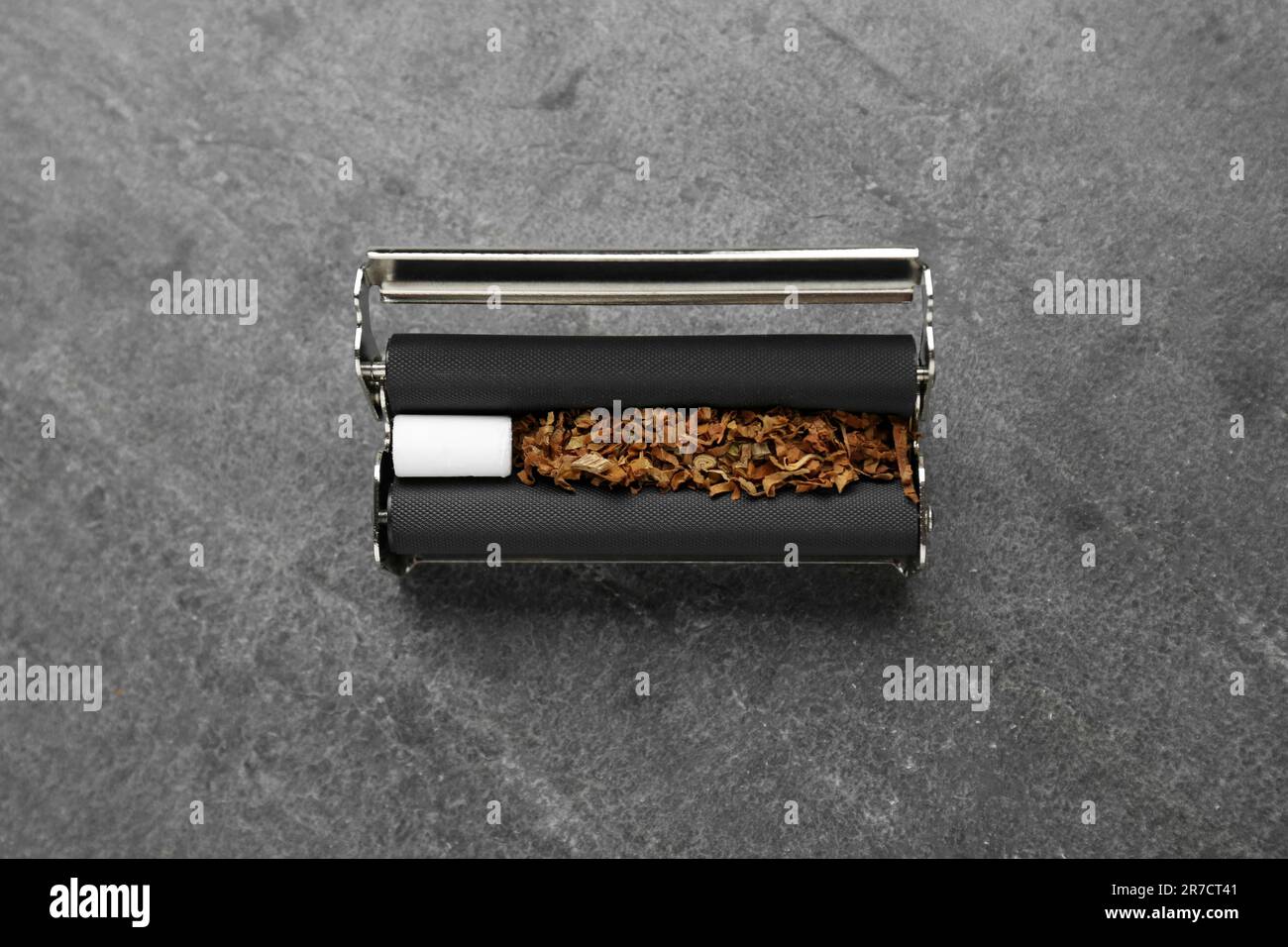 Cigarette roller with tobacco and filter on grey table, top view Stock ...