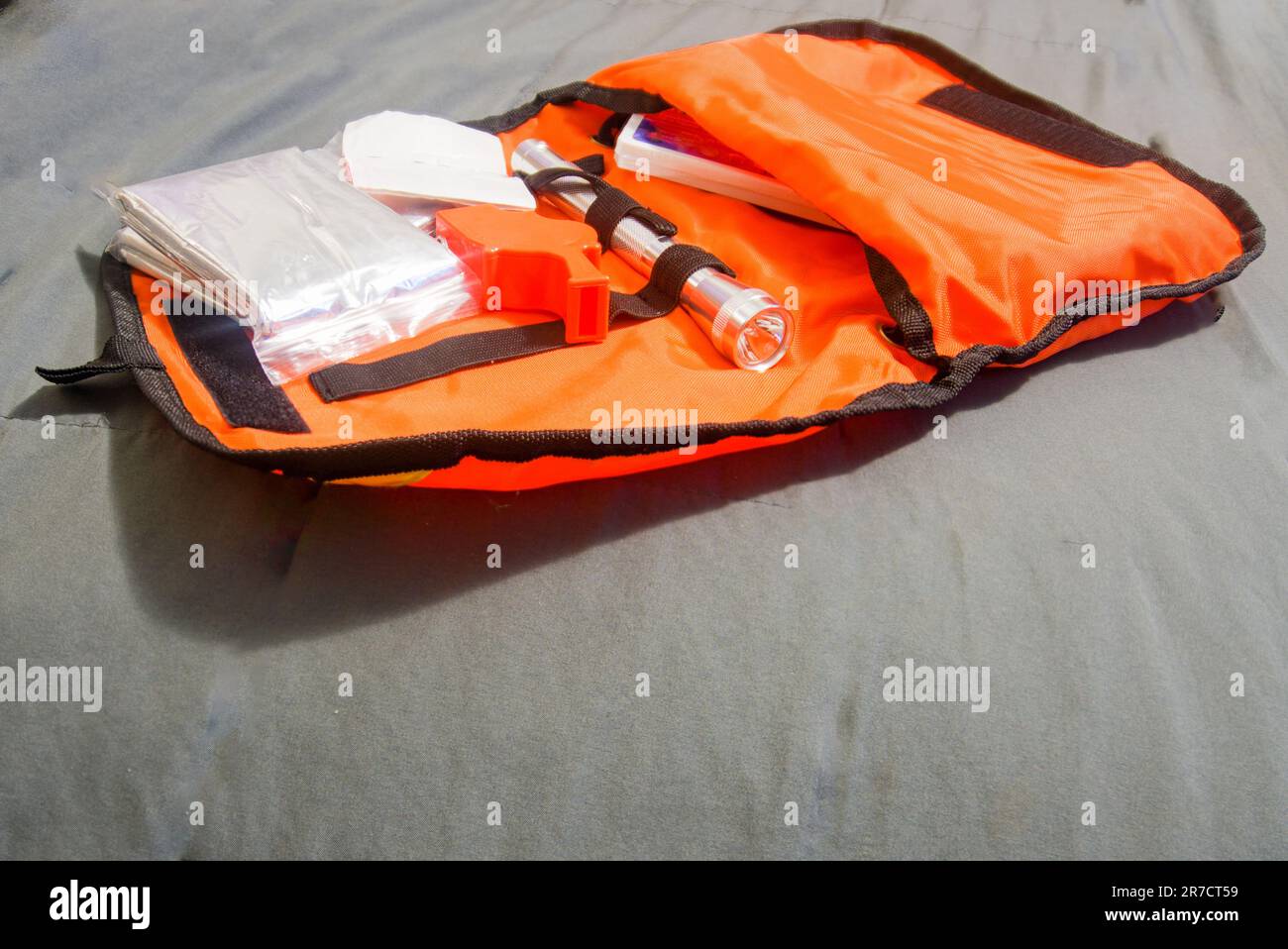 Photo of emergency survival kit on gray background with copy space ...