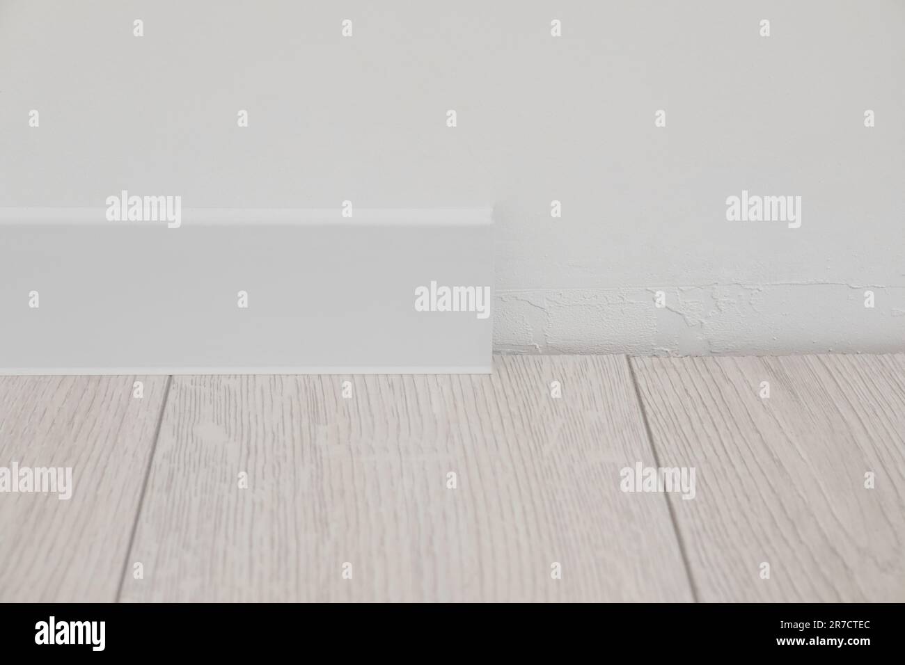 White plinth on laminated floor in room Stock Photo - Alamy