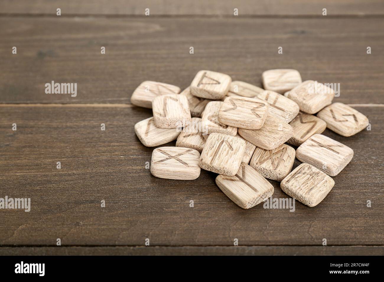 Pile of runes with different symbols on wooden table Stock Photo - Alamy