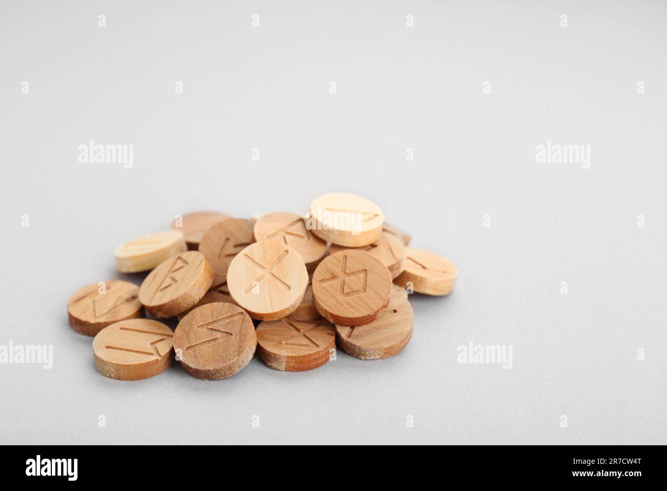 Pile of wooden runes on light grey background Stock Photo - Alamy