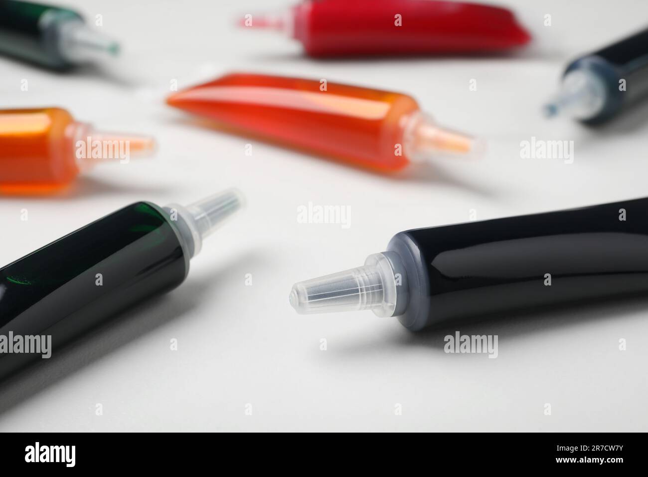Tubes with different food coloring on white background, closeup Stock ...