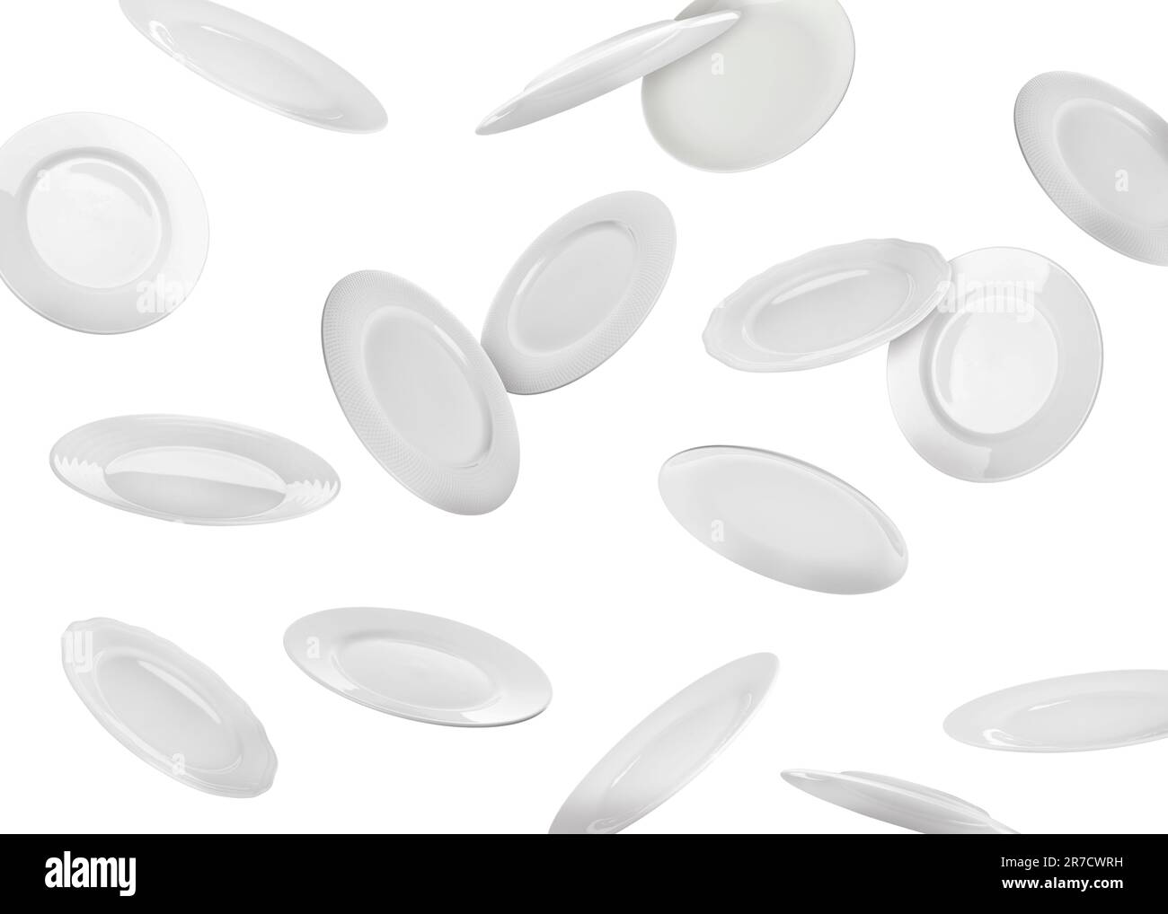 Many ceramic plates falling on white background Stock Photo - Alamy