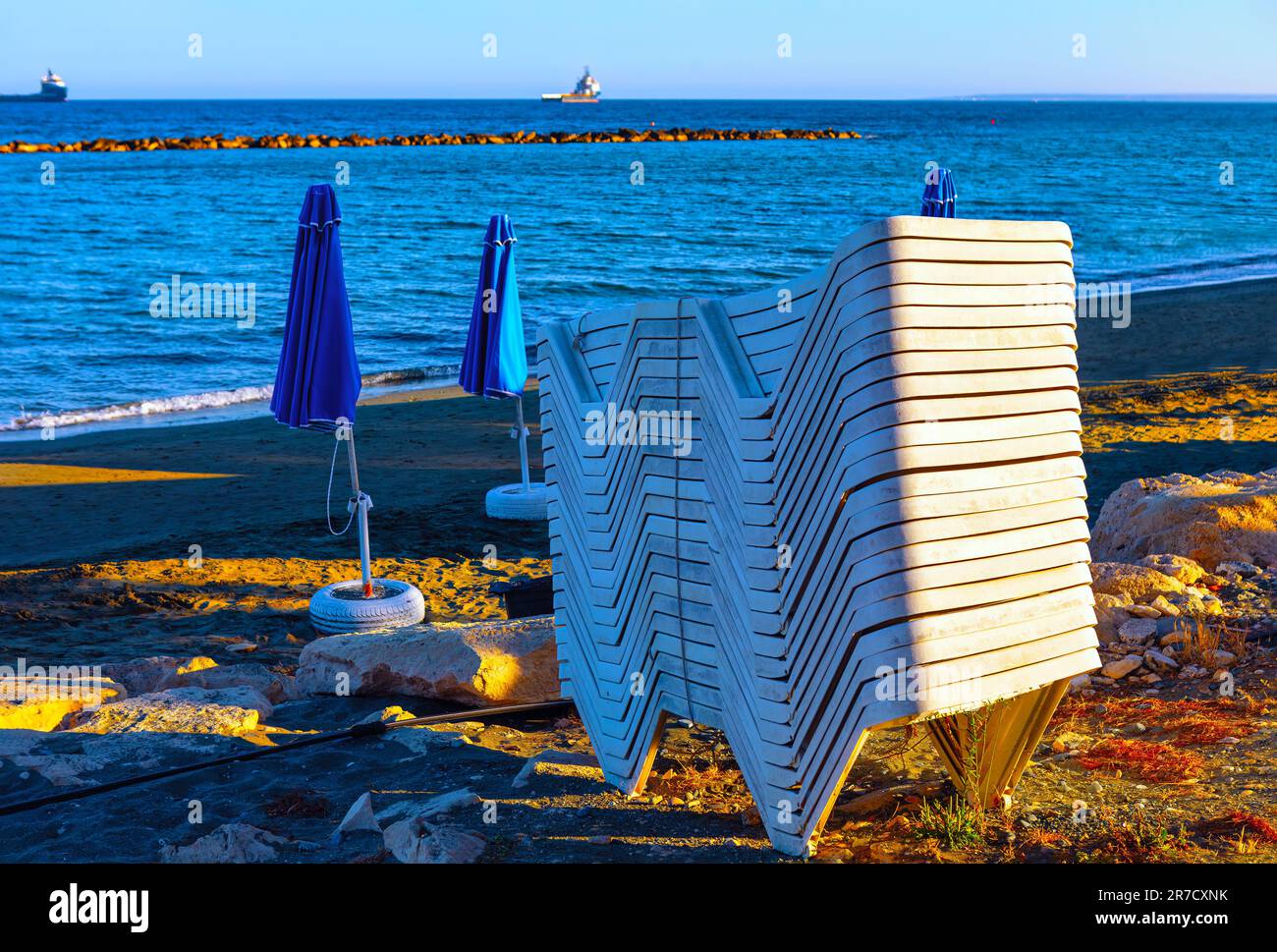 Outdoor beach furniture . Chaise Lounges stacked on the beach Stock ...