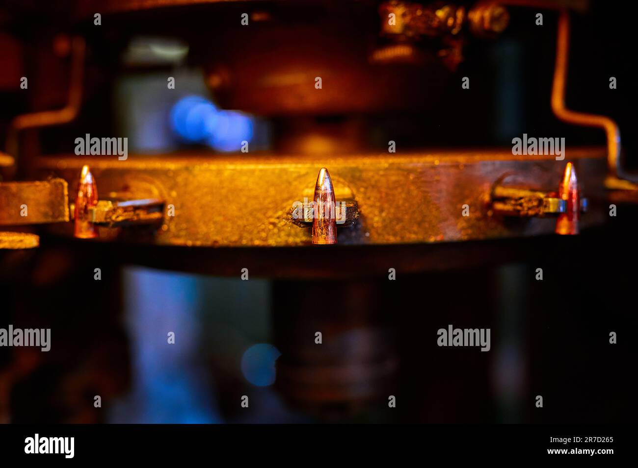 Round clamp with shiny bullet at ammo factory shop closeup Stock Photo ...