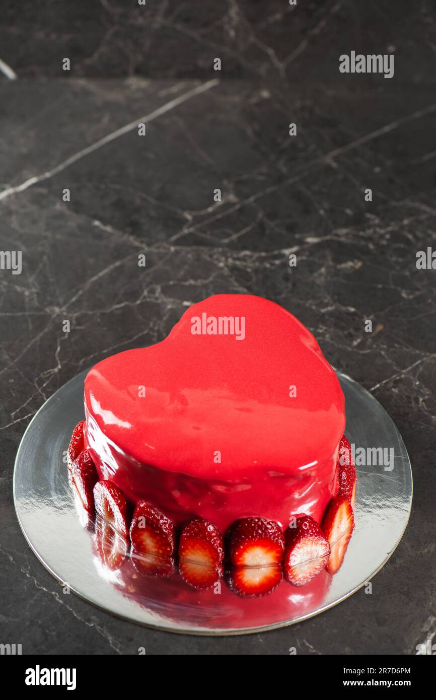 Beautiful heart-shaped moist mud cake with a ganache coating, red ...