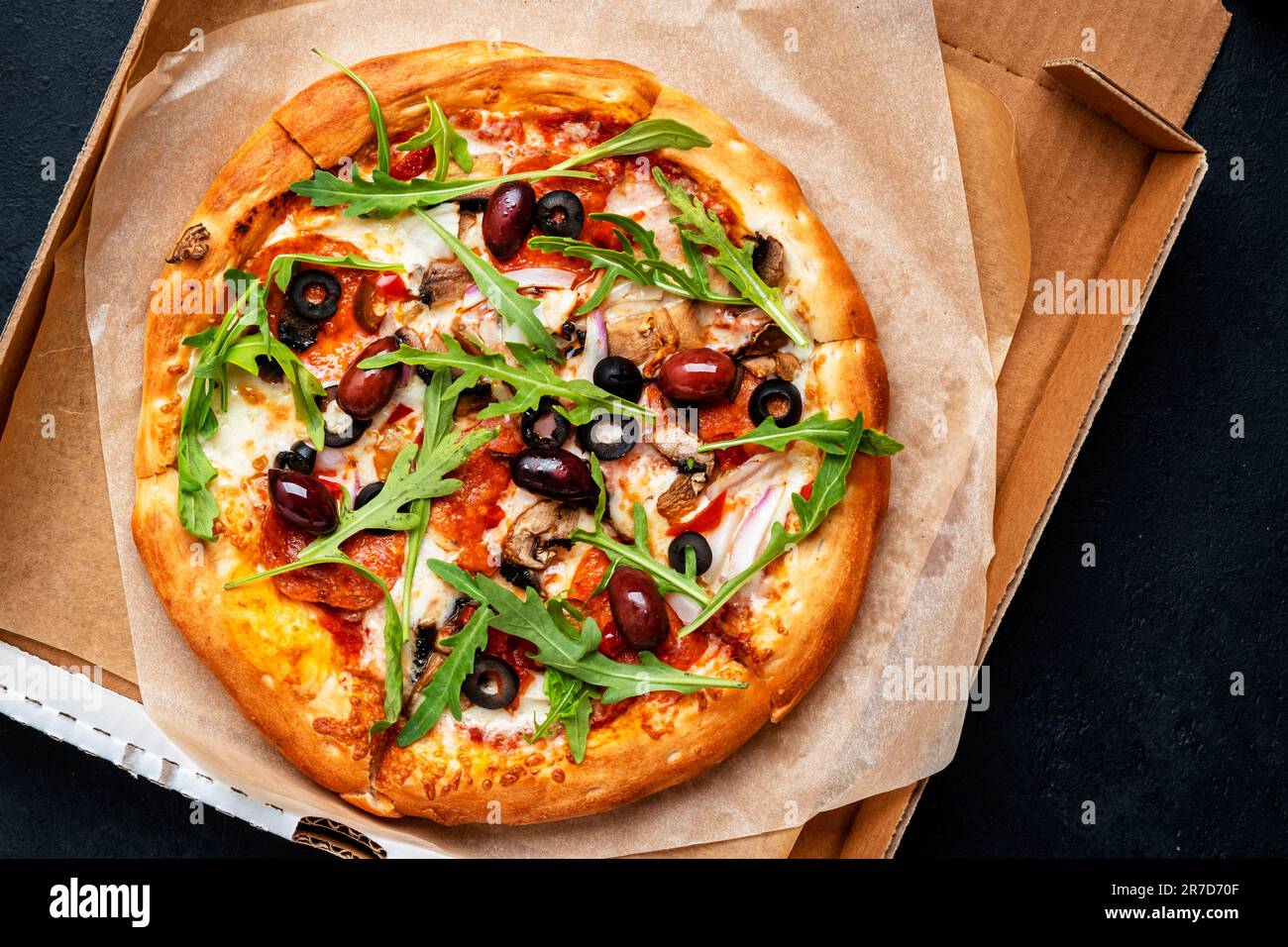 Hot pizza in box with spicy salami sausage, mozzarella cheese ...